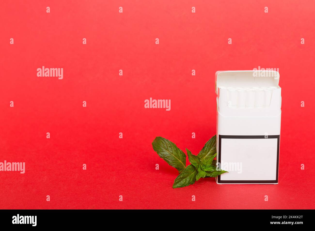 Pack of menthol cigarettes and fresh mint on colored table, Menthol ...