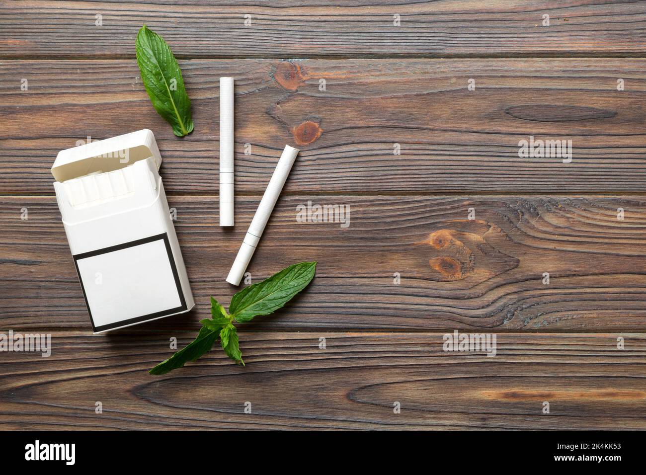 Pack of menthol cigarettes and fresh mint on colored table, Menthol ...
