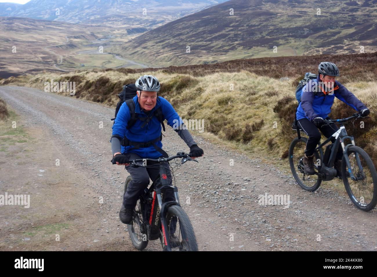 Two Elderly Men on Electric Bikes Cycling Off-road on a Track in Glen ...