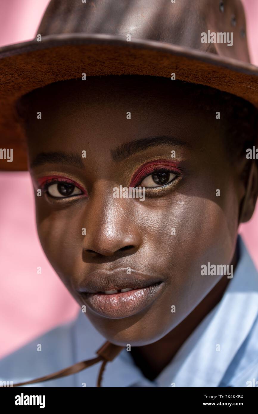 Close-up of an African girl. Portrait of a beautiful face. Wearing hat ...