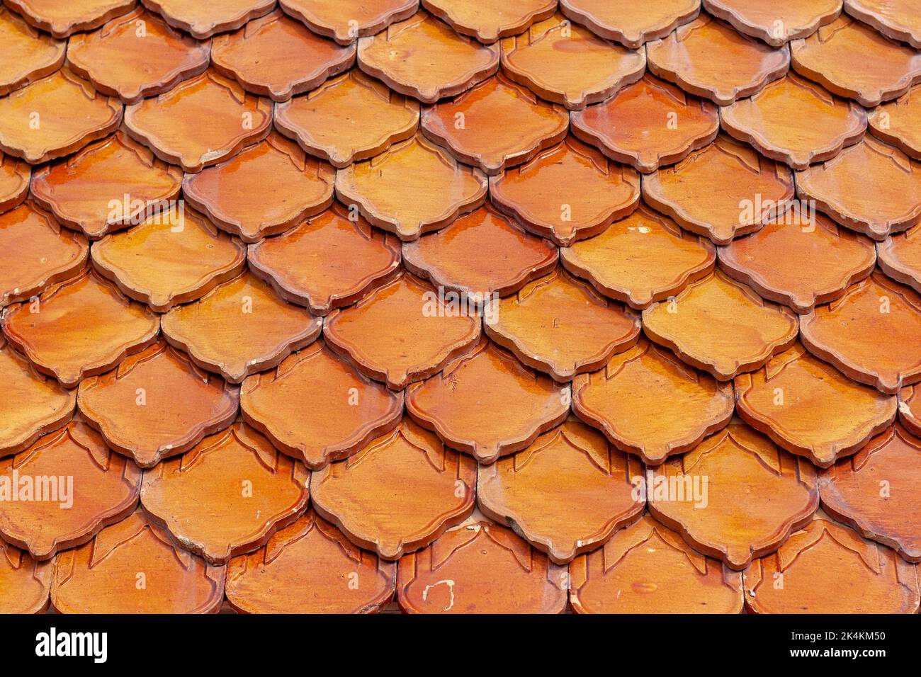 Orange clay tiles overlapping each other on the roof. Geometric pattern ...