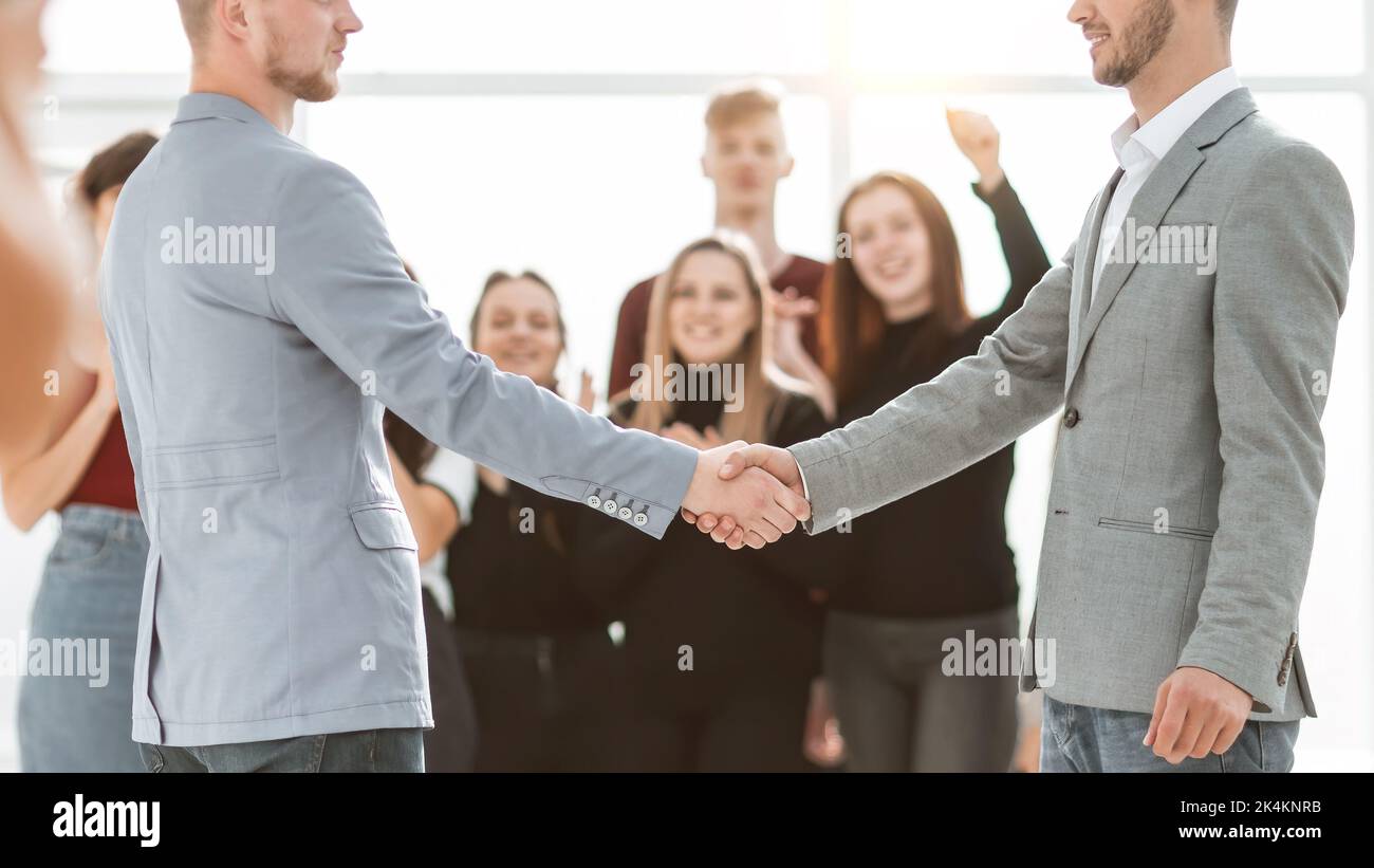 young business people shaking hands standing in the conference room ...