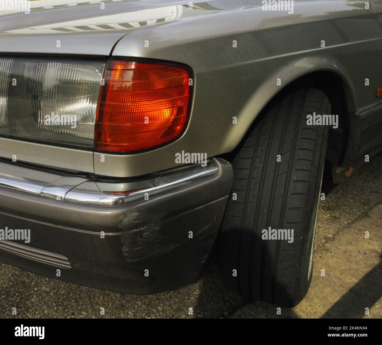 A closeup of an old car with a scratch on the bumper Stock Photo - Alamy