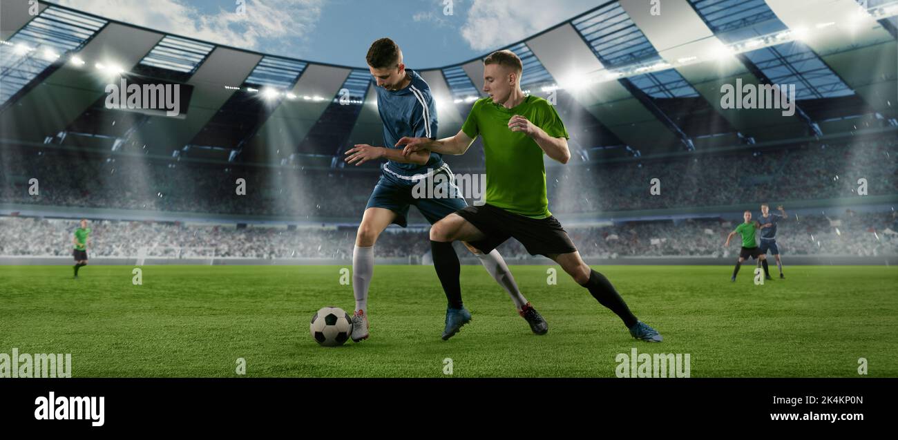 Goalmouth scramble. Two male soccer, football players dribbling ball at ...