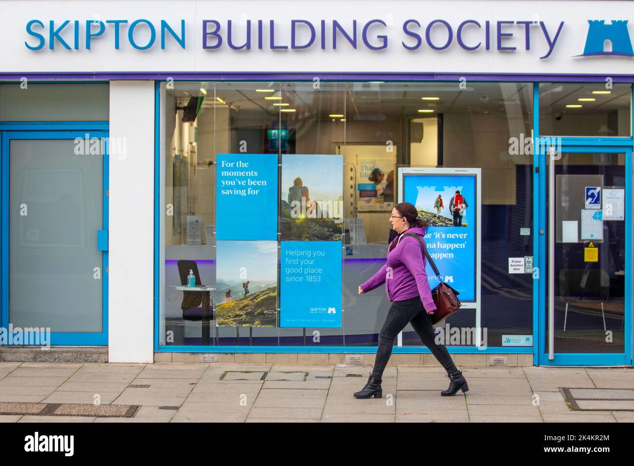 Woman passing Skipton Building Society in Southport town centre, UK ...