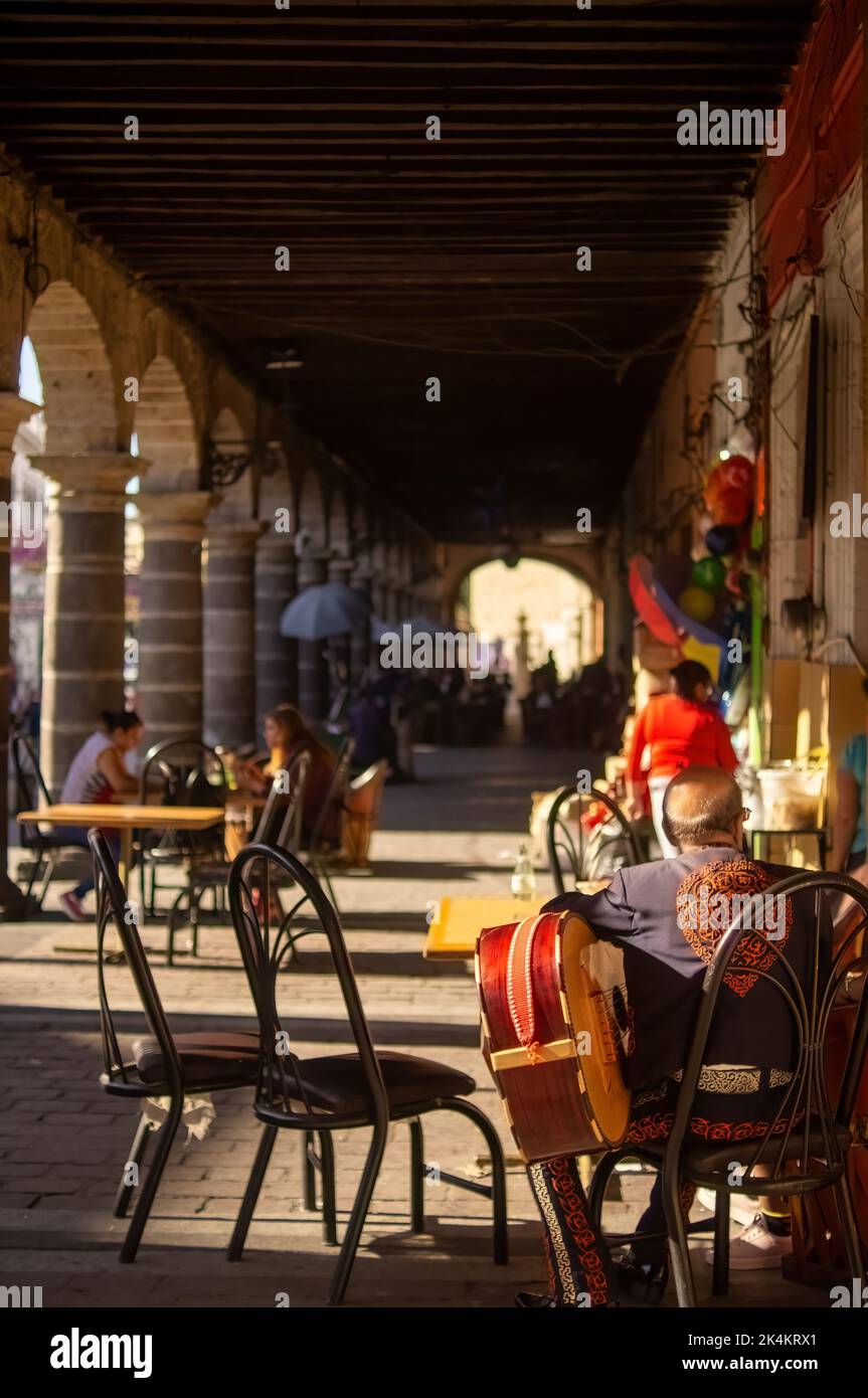 happy old man, sitting waiting, sitting on steps while drinking a cola ...