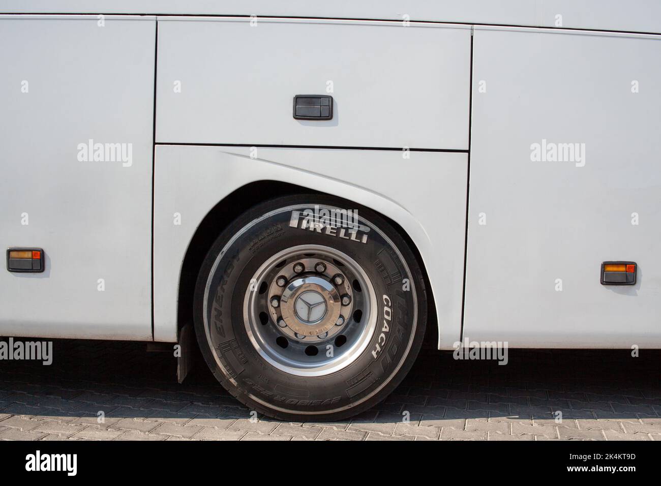 Huge bus wheel with a shiny disc. White bus wheel arch. Pirelli tire ...