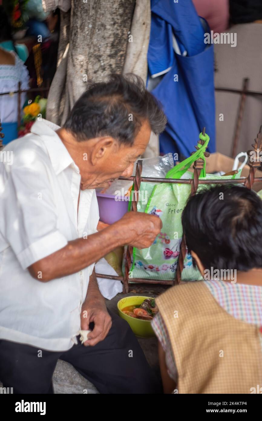 old man, eating a guacamole tostada with tequila, family reunion ...