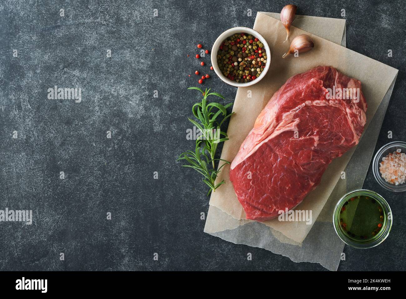 Steaks. Fresh New York Steaks raw with spices rosemary and pepper on ...