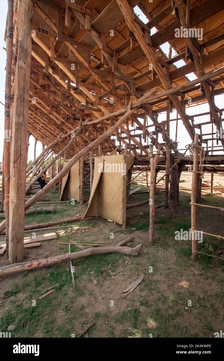 man making wooden roof, mason making roof formwork, with cap and hammer ...