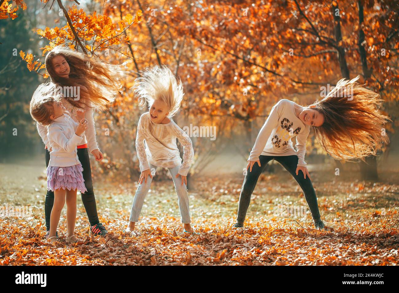 Four girls dancing in the autumn park Stock Photo - Alamy