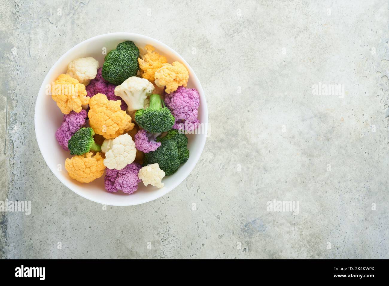 Colorfu cauliflower. Cauliflower cut into small pieces white bowl on ...