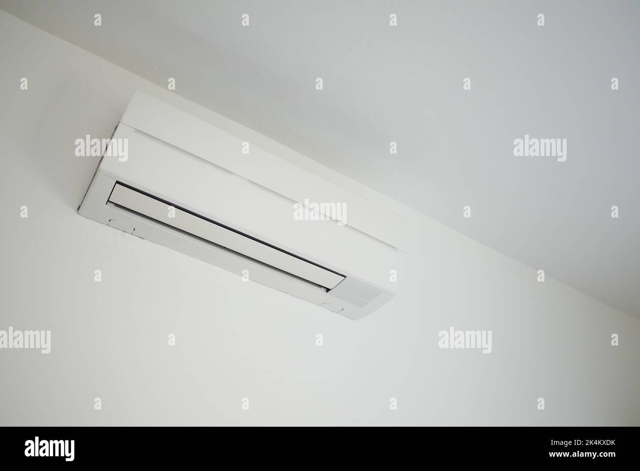 flat air conditioner on white wall Stock Photo - Alamy