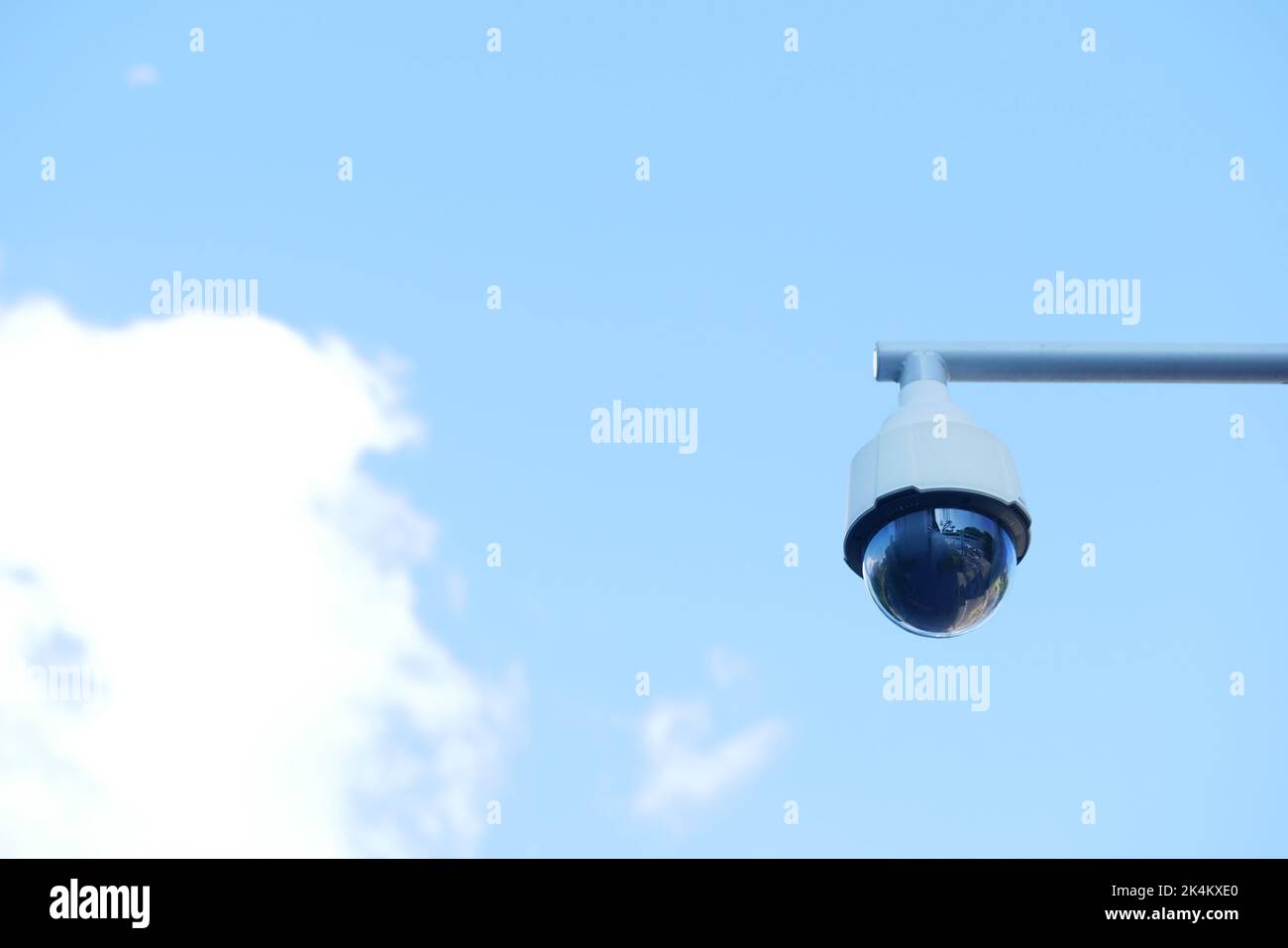 CCTV security camera operating against blue sky Stock Photo - Alamy