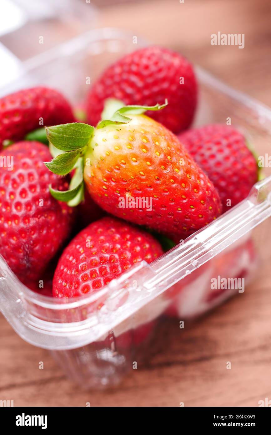 Ripe Red Strawberries in a plastic packet on table Stock Photo - Alamy