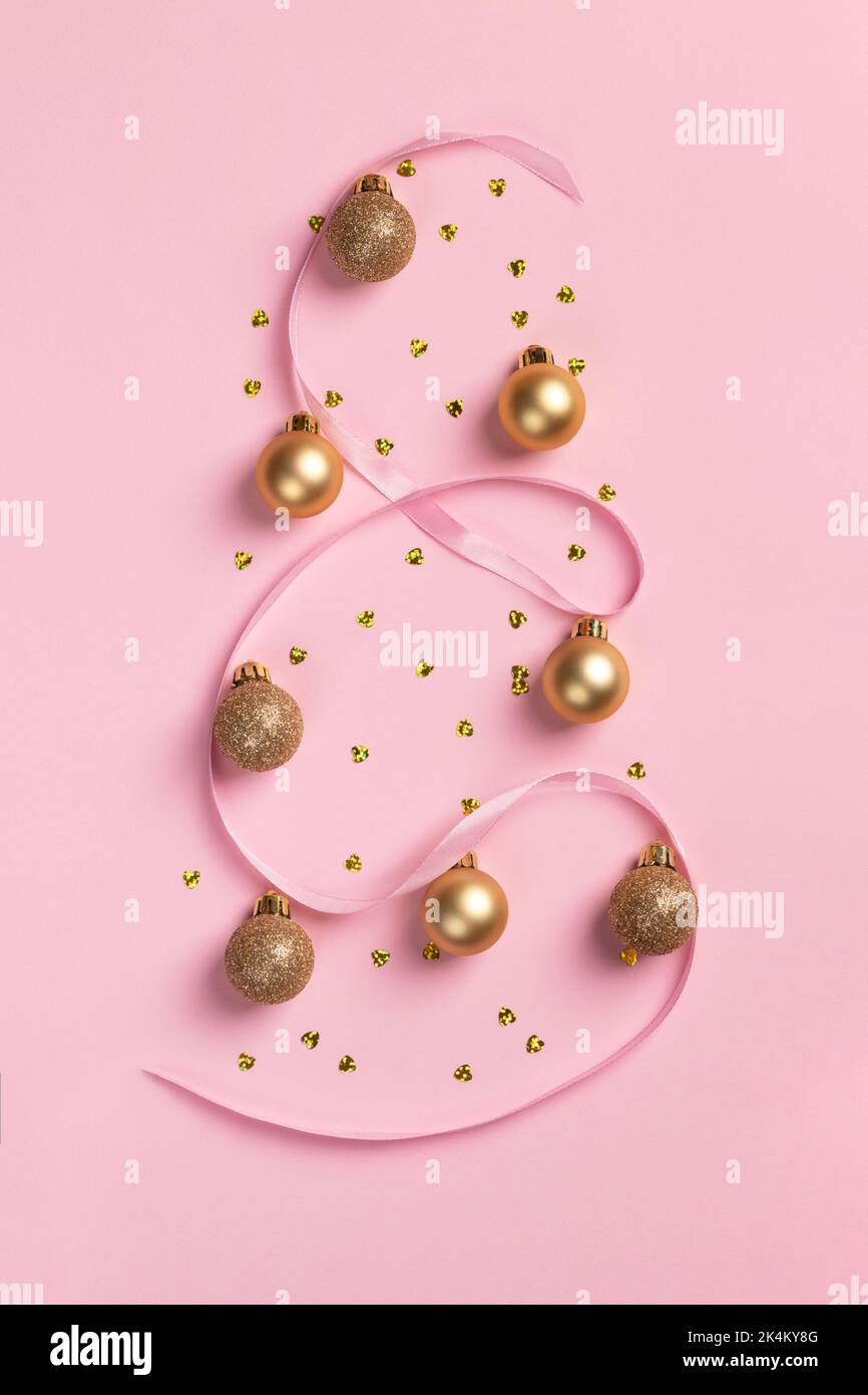 Christmas card with golden glitter balls, confetti in the form of heart ...