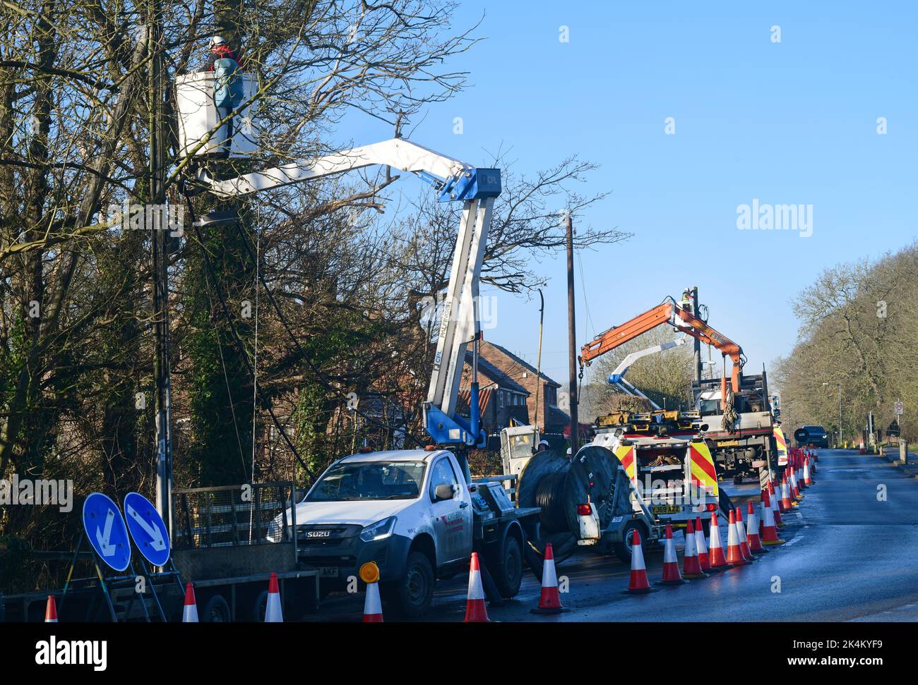 engineer in cherry picker carrying out repair work on electricity power ...