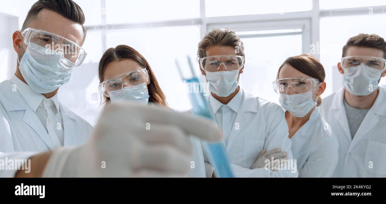 background image is a group of medical workers working with liqu Stock ...
