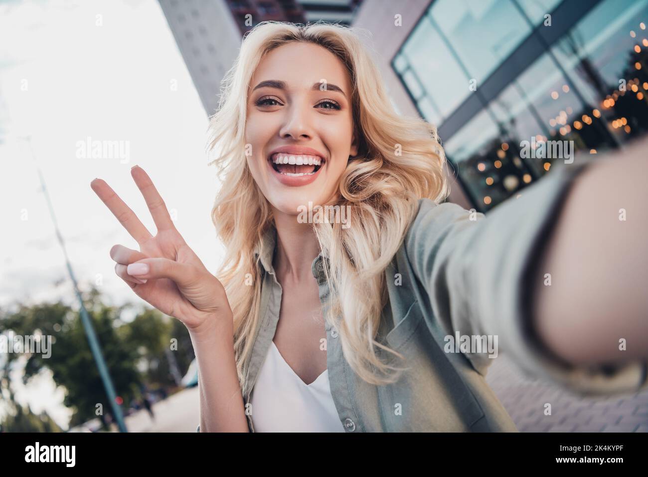 Self portrait of attractive cheerful wavy haired girl having fun on ...