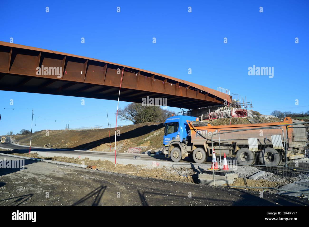 heavy earth moving machinery passing under bridge on Leeds Orbital road ...