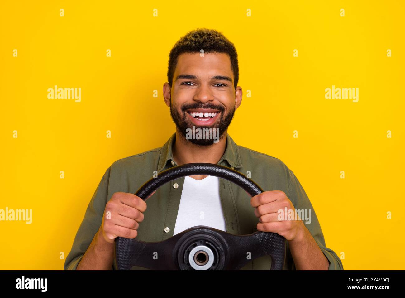 Photo of positive good mood man wear khaki shirt driving vehicle ...