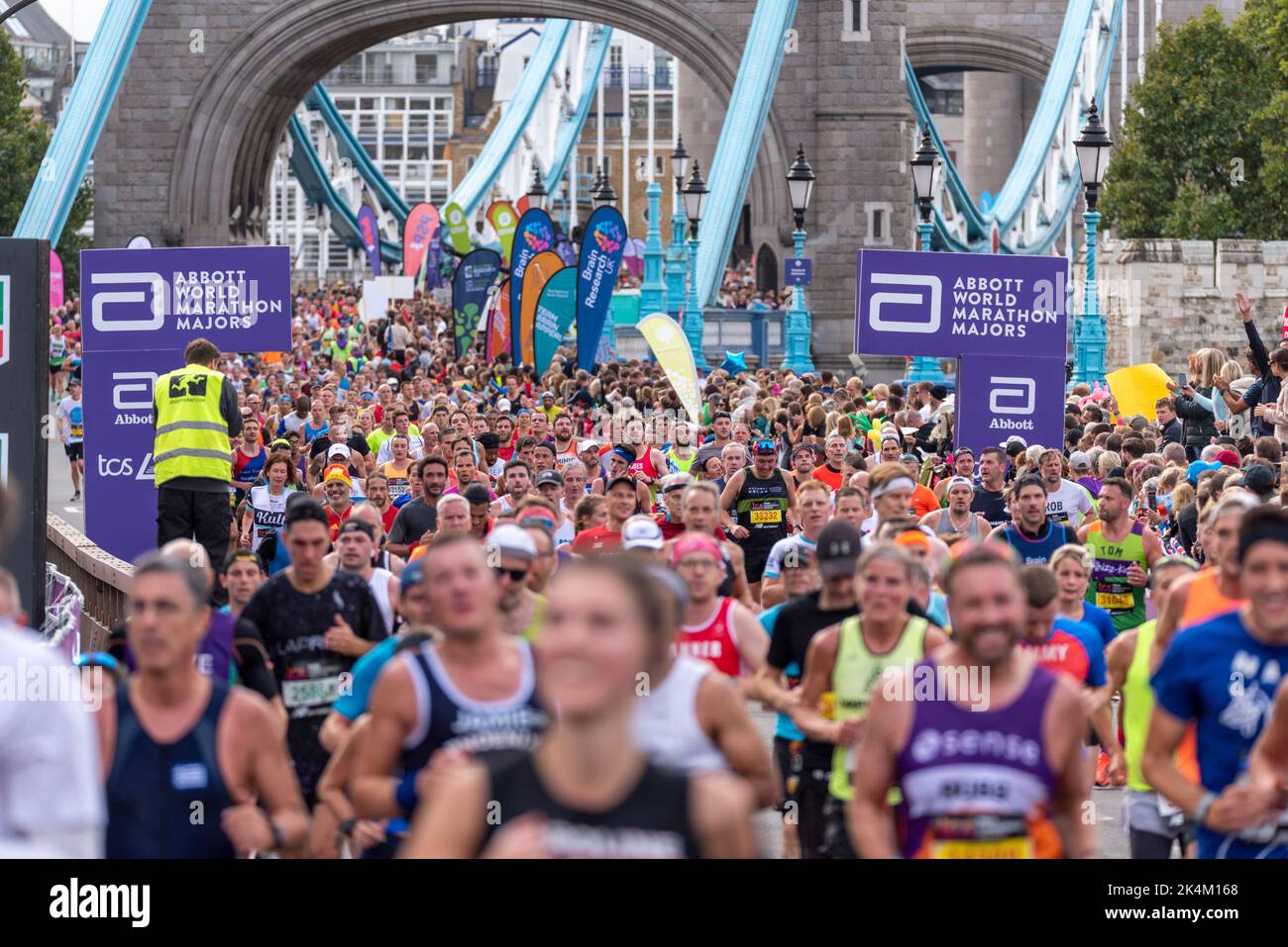 Mass of runners running in the TCS London Marathon 2022, on Tower ...