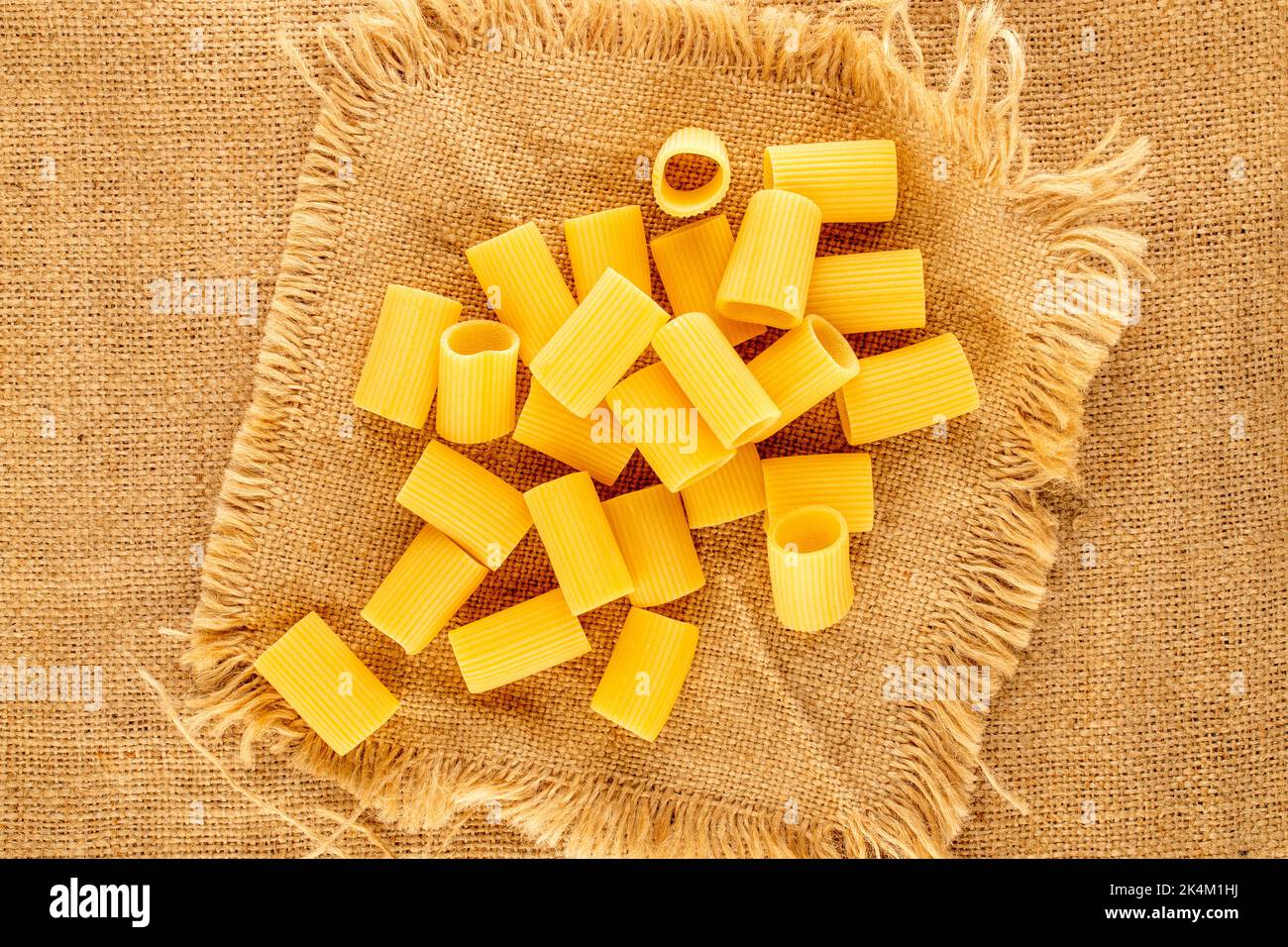 Several raw yellow cannelloni on a jute cloth, macro, top view Stock ...