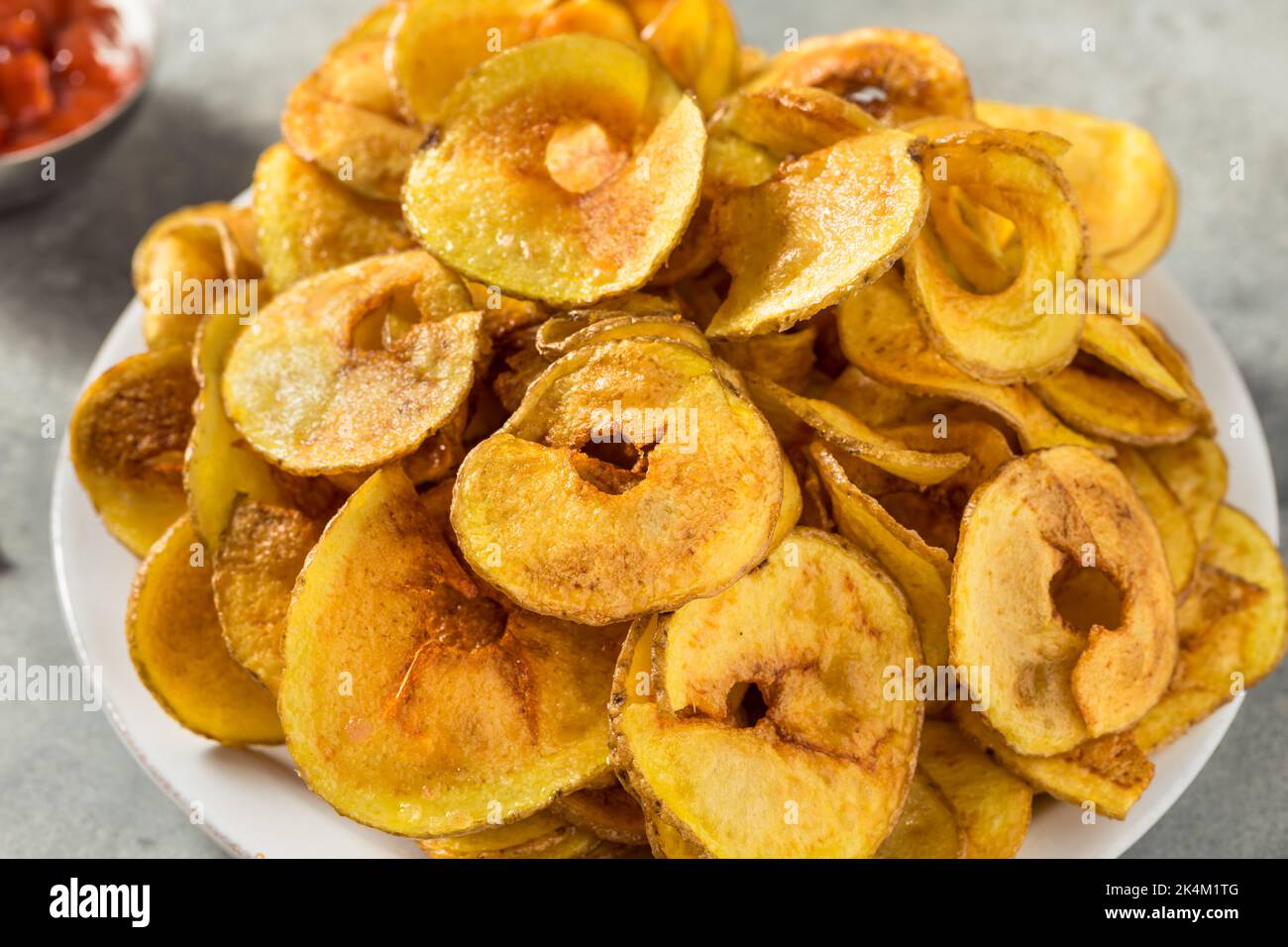 Homemade Spiral Cut Potato Chips with Salt and Ketchup Stock Photo - Alamy