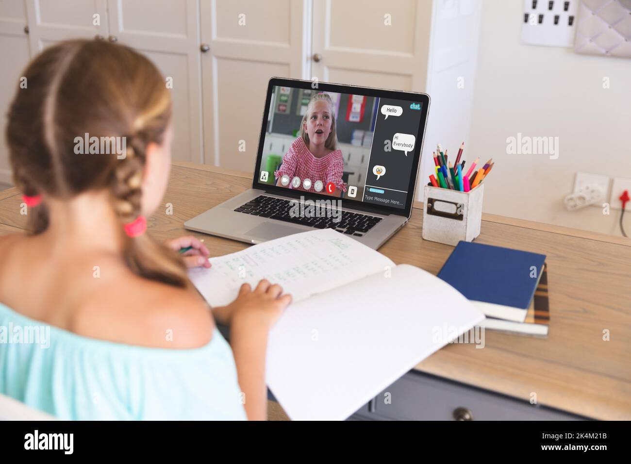Caucasian girl using laptop for video call, with elementary school ...