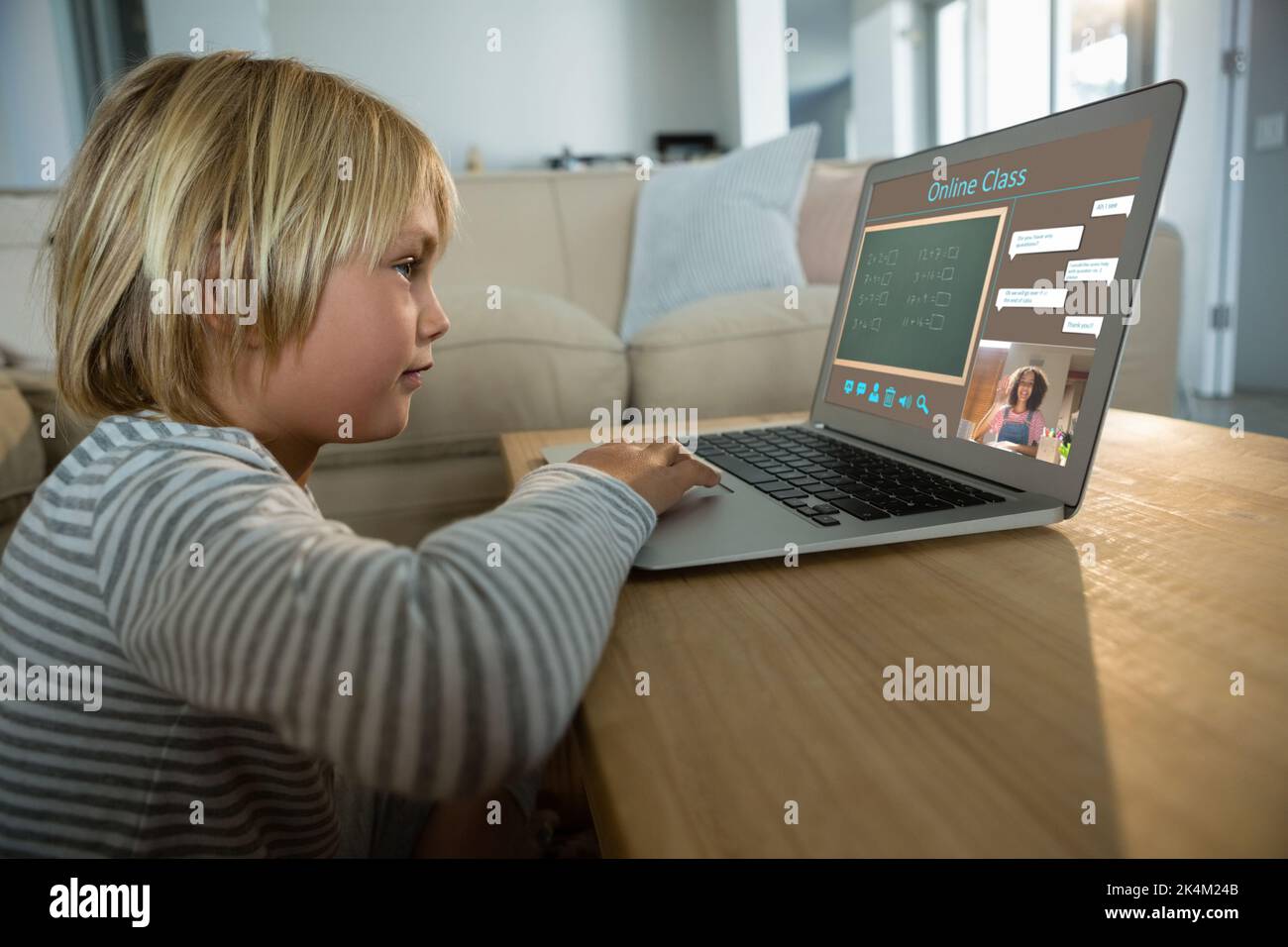 Caucasian boy using laptop for video call, with female teacher on ...