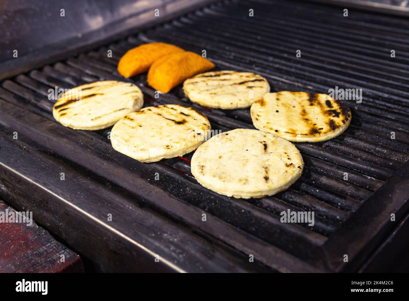 Colombian arepas and empanadas grilled on a grill. Colombian ...
