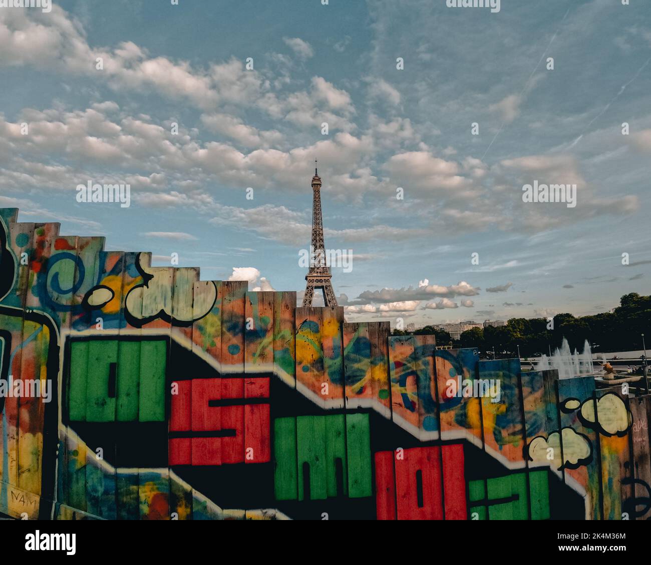 A graffiti wall with Eiffel Tower in the background. Paris, France ...