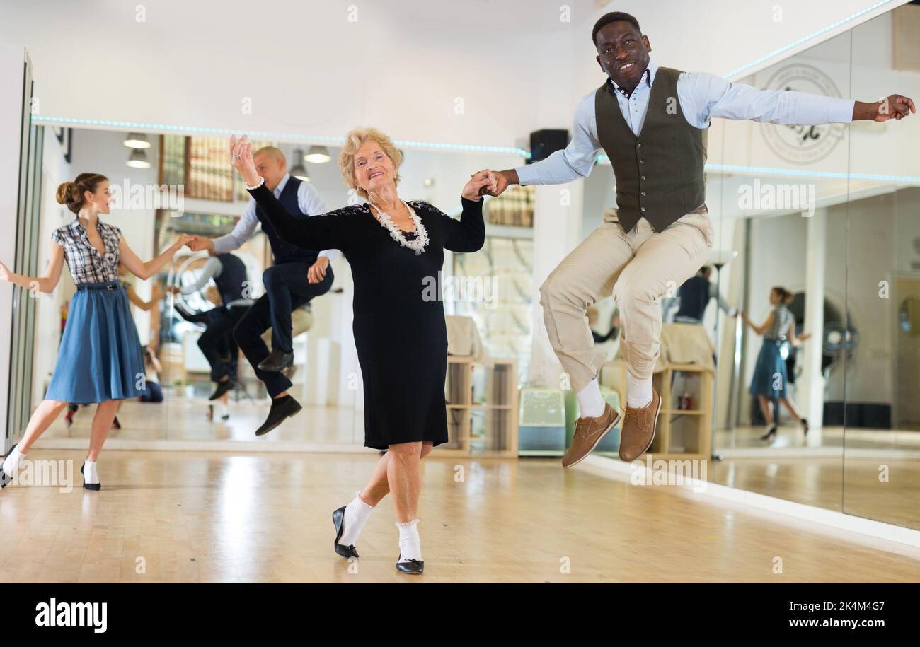 Senior woman and man dancing swing in studio Stock Photo - Alamy