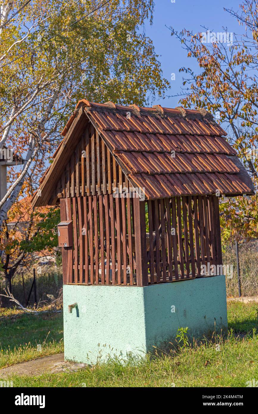 Water Well in Wooden Enclosure With Roof in Village Stock Photo - Alamy