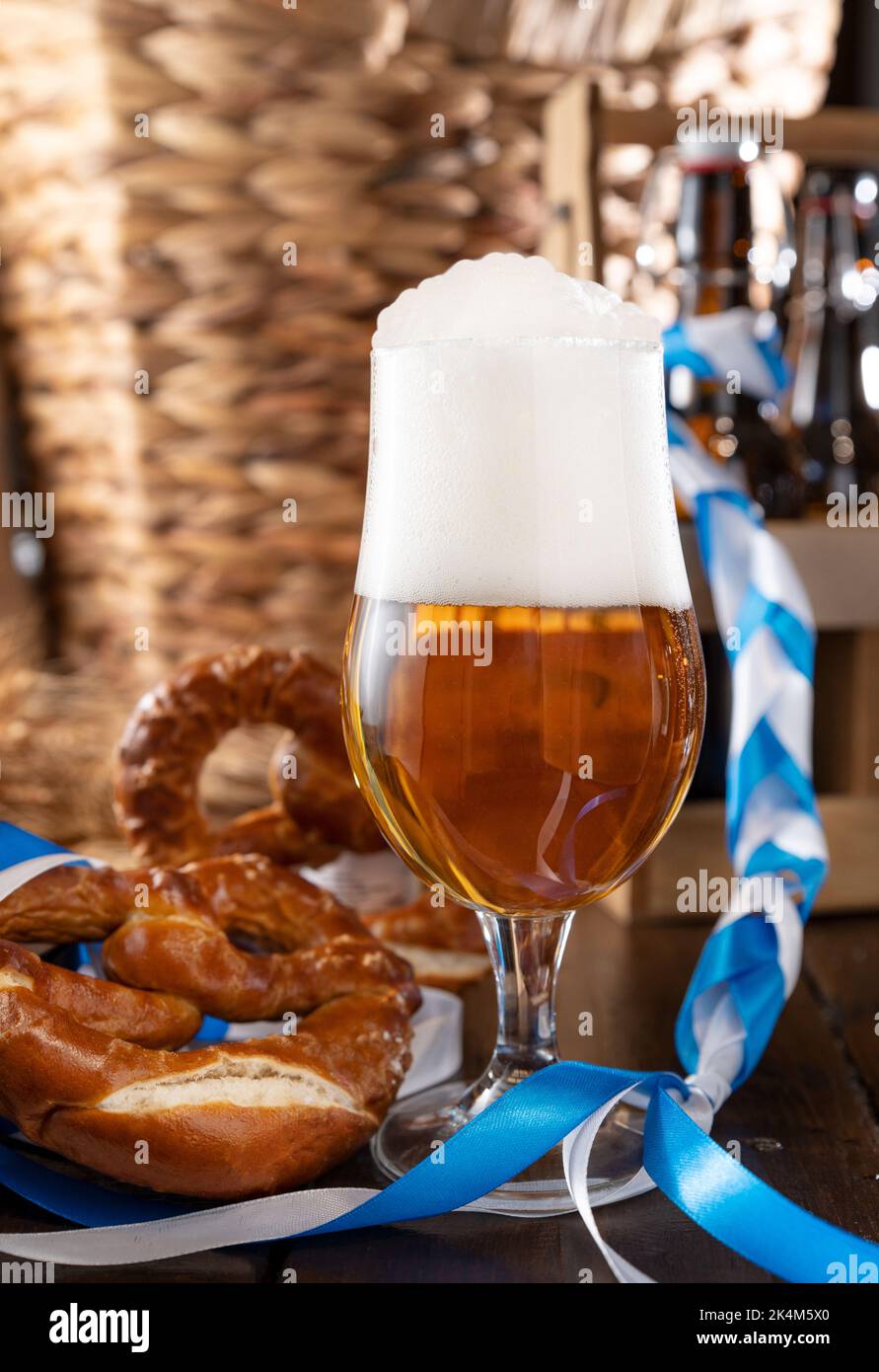 Oktoberfest beer. Foamy beer is poured into a glass and the decor of ...