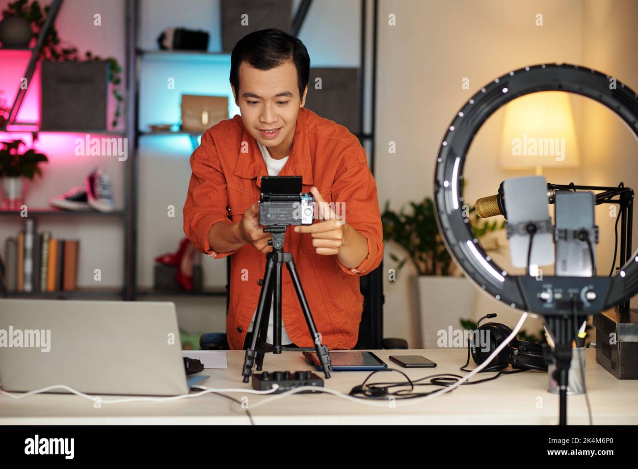 Horizontal medium portrait of modern Asian blogger getting ready for ...