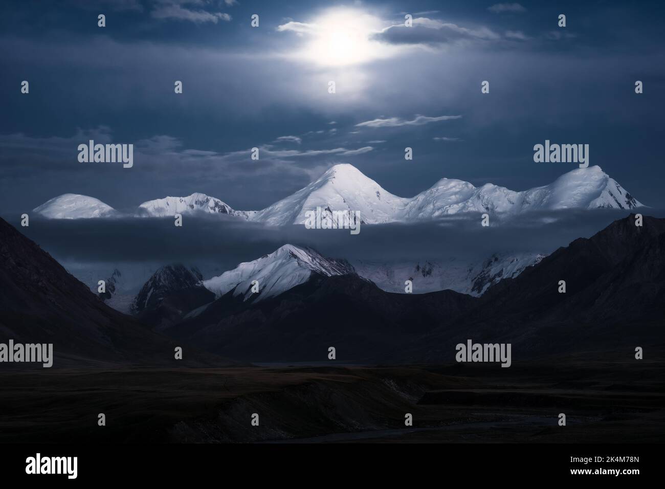 Moonlit snow-capped peaks of the Tien Shan mountains in Sary Jaz valley ...