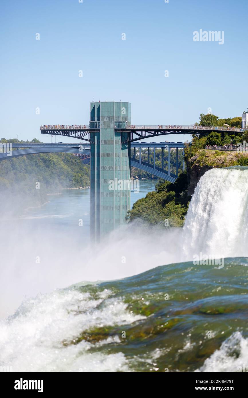 A raging waterfalls with a bridge background Stock Photo - Alamy