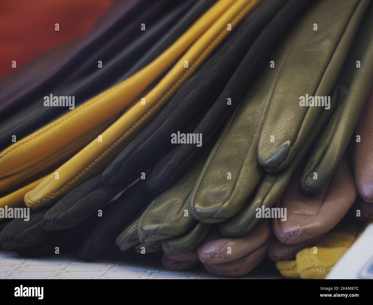 many different colors leather gloves on display Stock Photo - Alamy