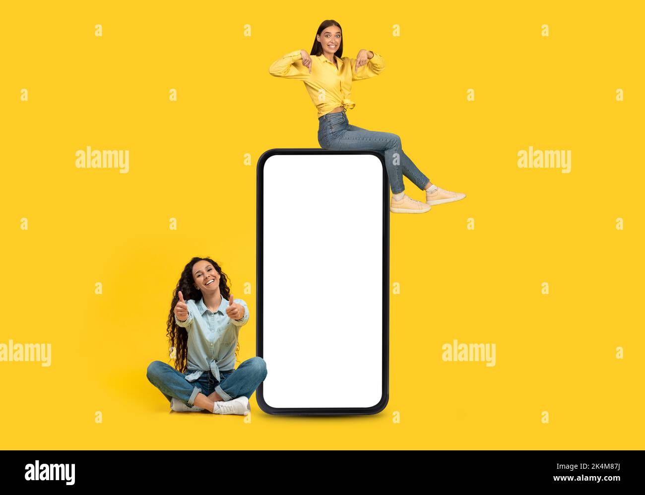 Happy european young woman sit on phone, have fun, show thumbs on big ...