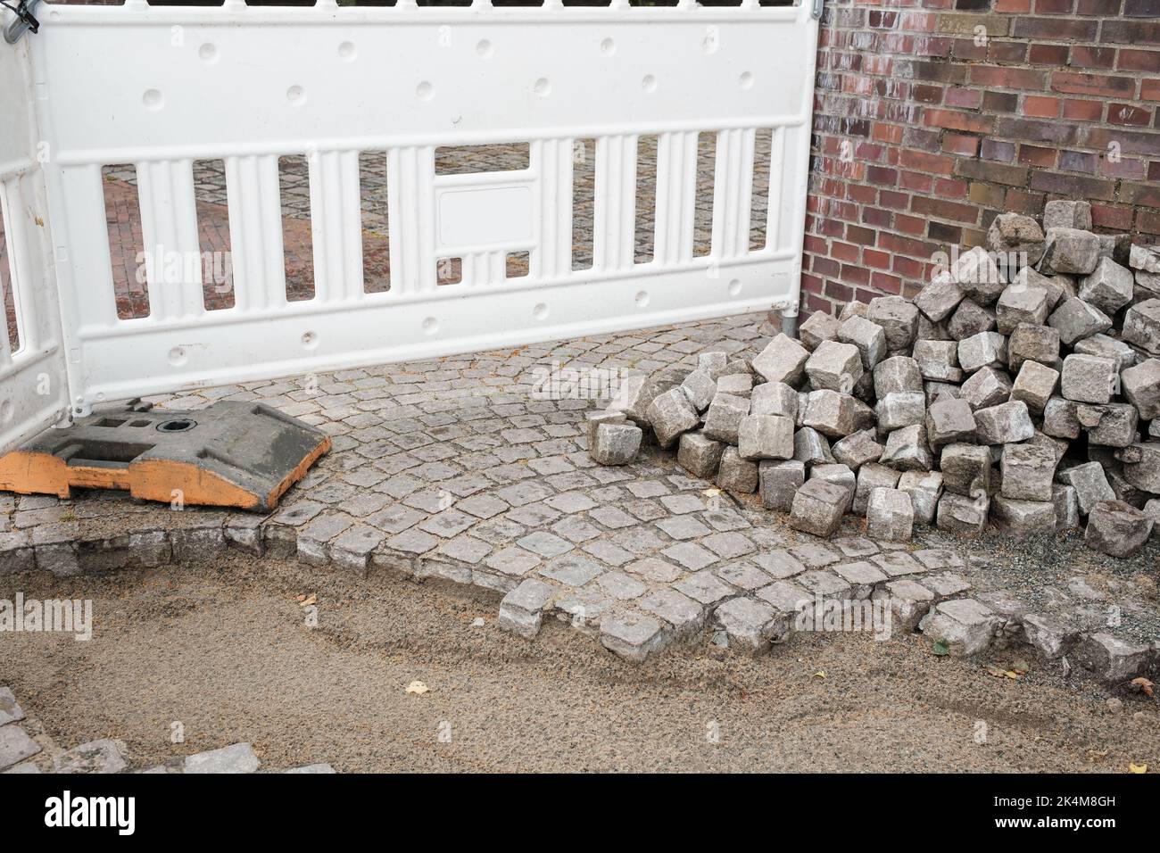 repair of paving stones of a pedestrian path on a city street in Europe ...
