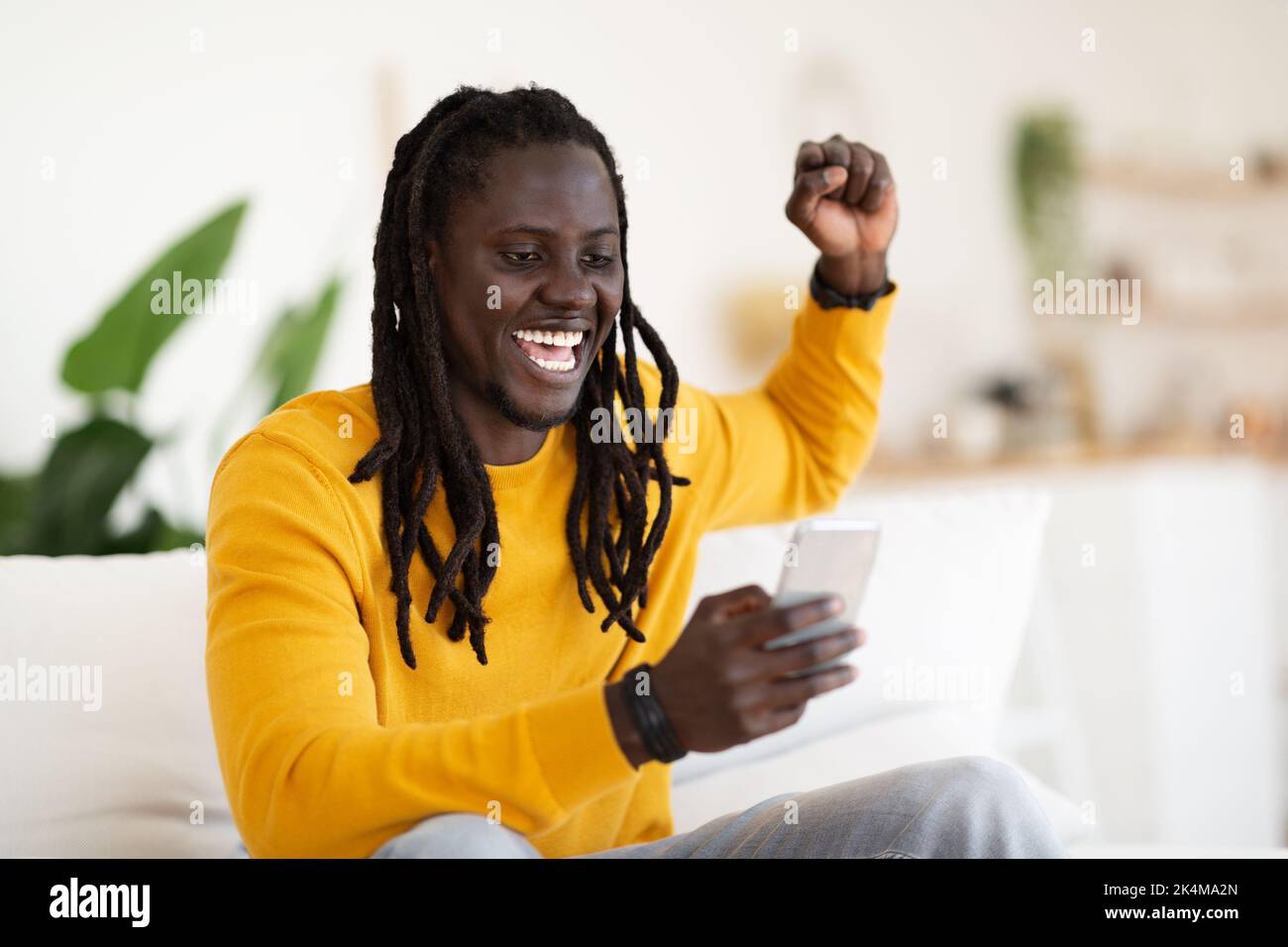 African man celebrating success using hi-res stock photography and ...