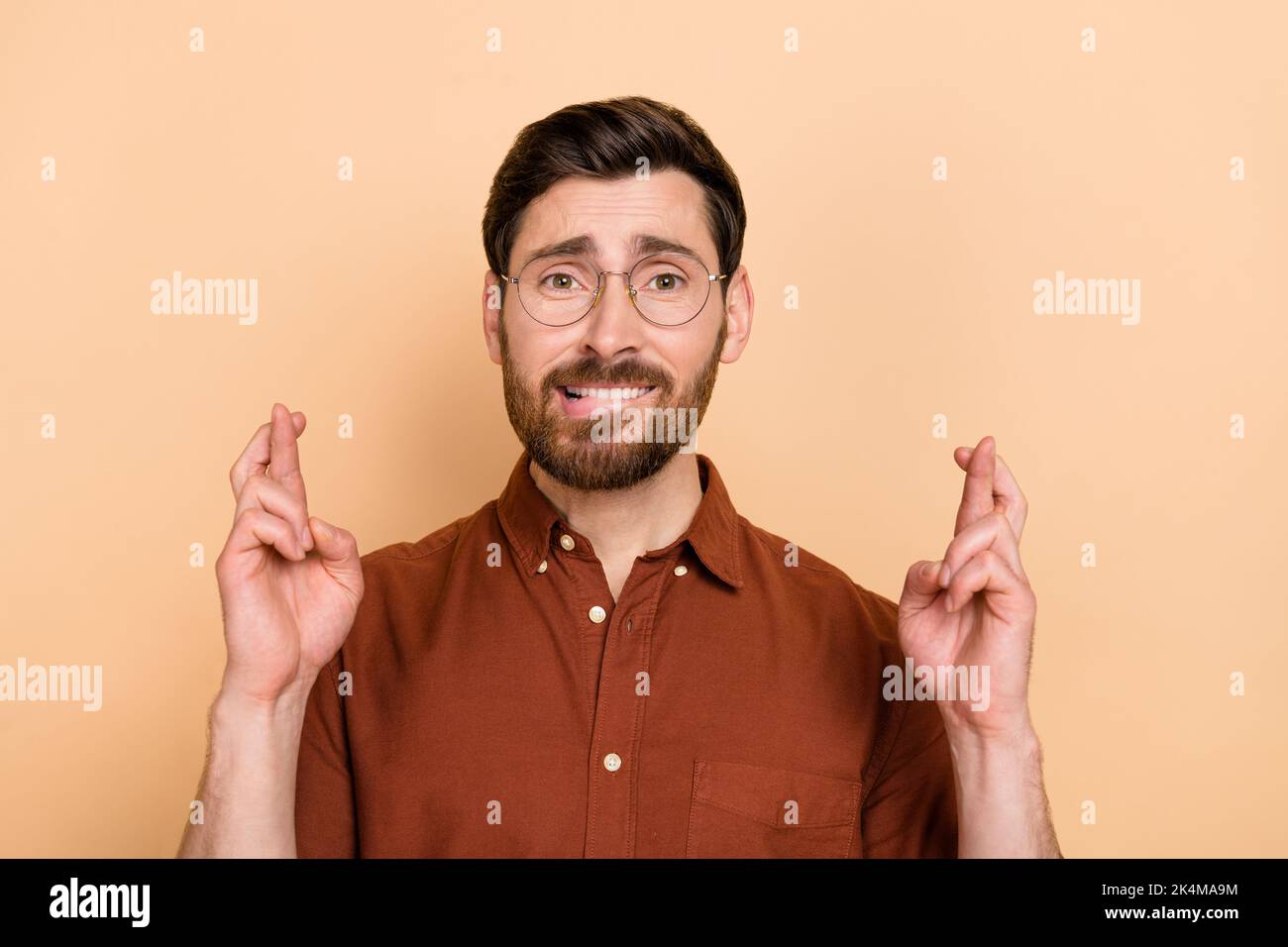 Portrait of anxious nervous person crossed fingers biting lips isolated ...