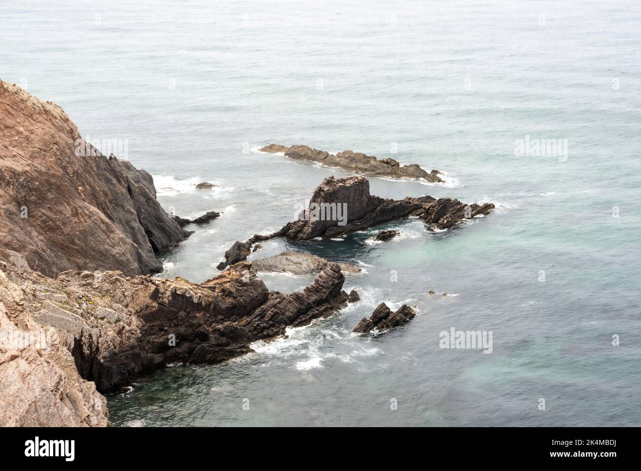 Eroded rocks emerging from the Atlantic ocean showing signs of erosion ...