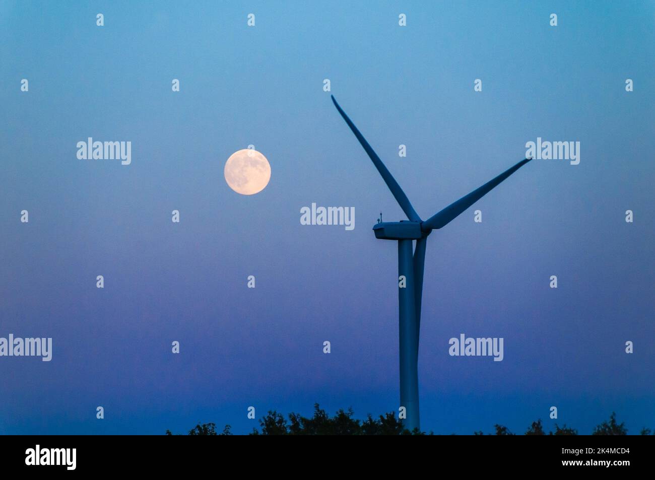Moonrise over a lone wind turbine in Dexter Minnesota USA Stock Photo ...