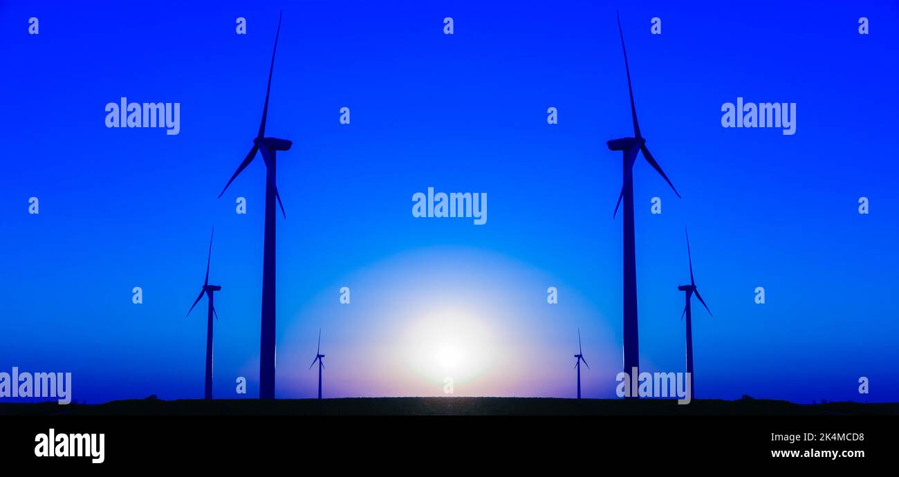 Mirror image silhouette of large wind turbine farm at sunset, Dexter ...