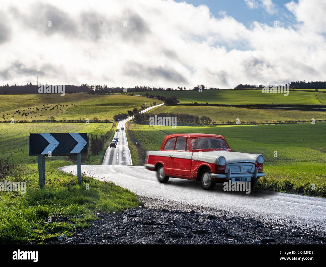 Triumph Herald model from Airfix kit travels on rural road over rolling ...