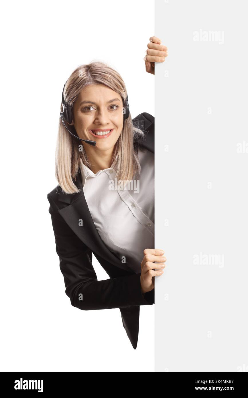 Female dispatch worker with a headset standing behind a blank white panel isolated on white ...