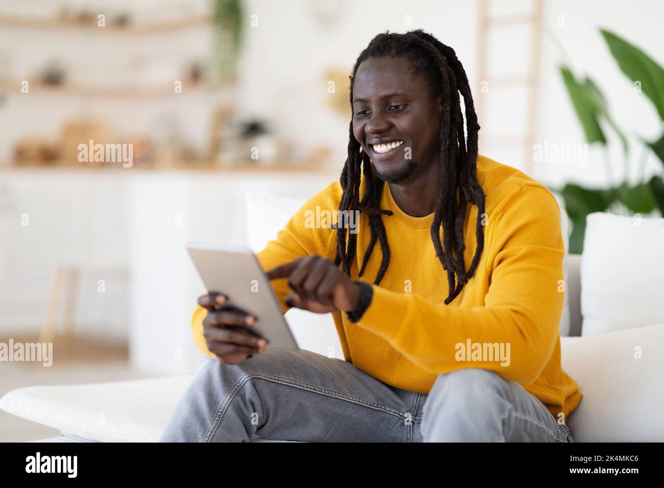 Technologies For Leisure. Black Happy Man Using Digital Tablet At Home ...