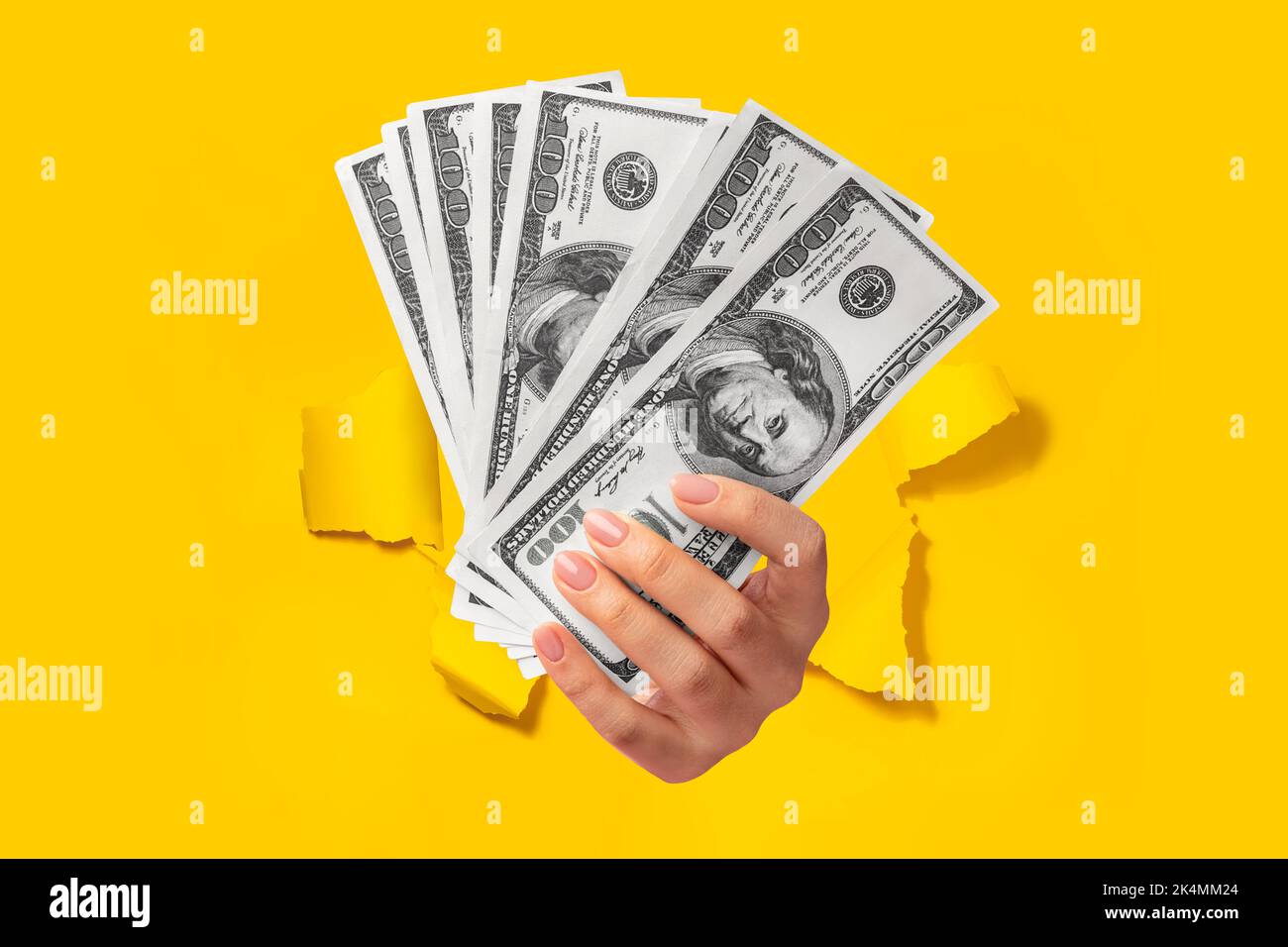Female hand holding fan of cash money in dollar banknotes, isolated ...